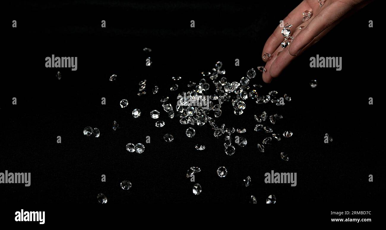 Hand of Woman with Diamonds against Black Background Stock Photo - Alamy