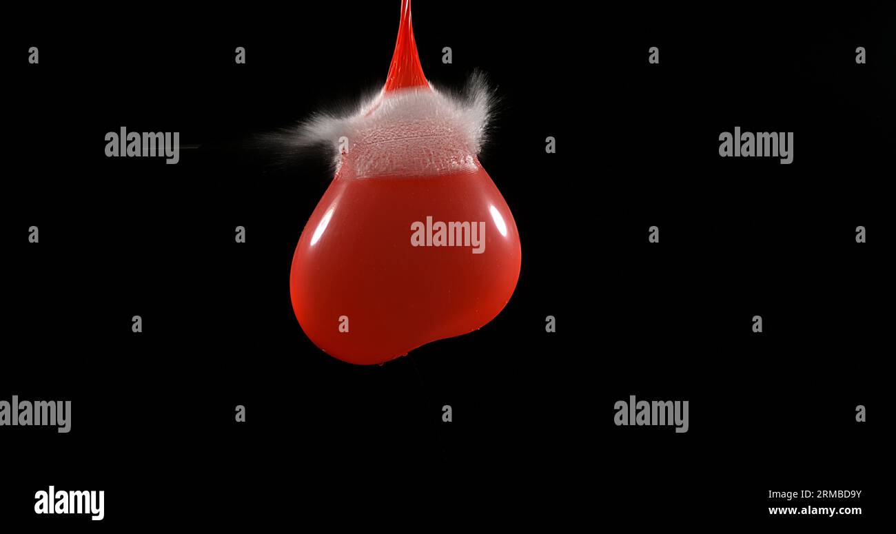 Shot Breaking Water Filled Red Balloon Stock Photo - Alamy