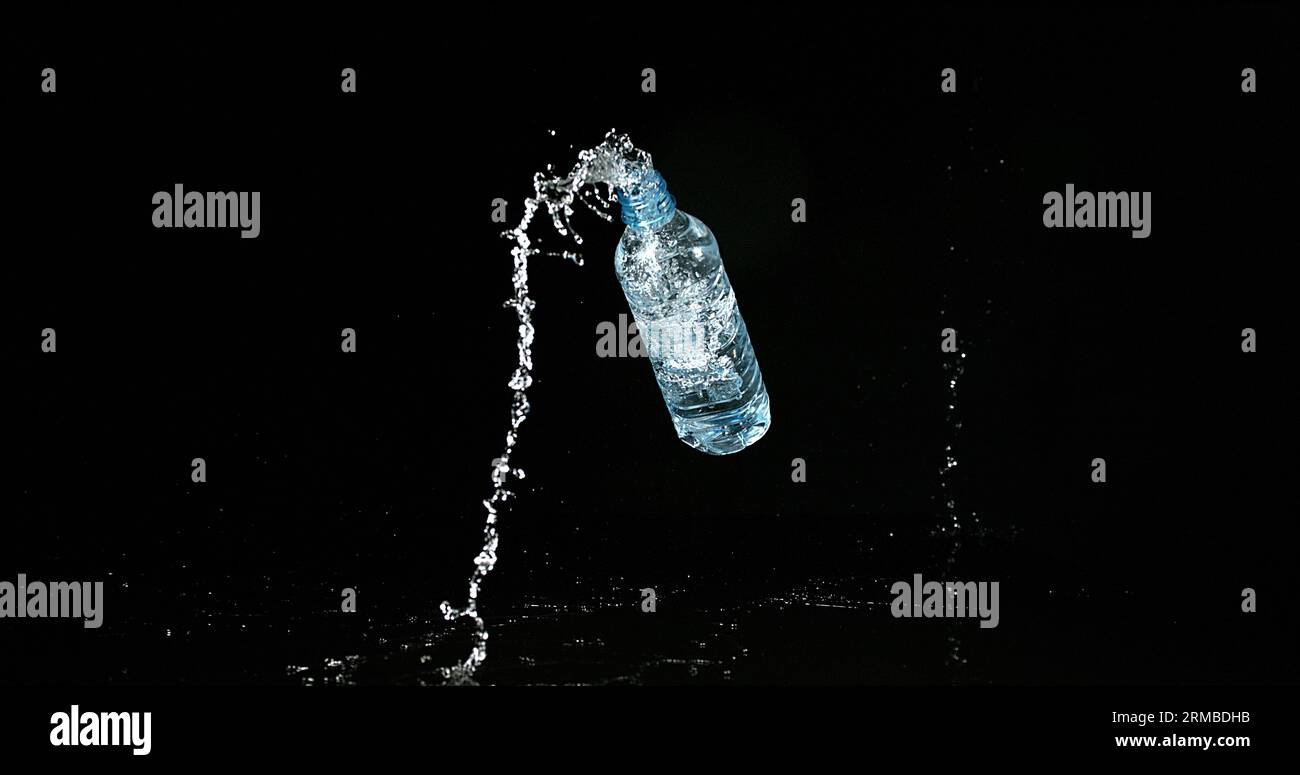 Plastic Bottle of Water falling and Splashing against Black Background ...