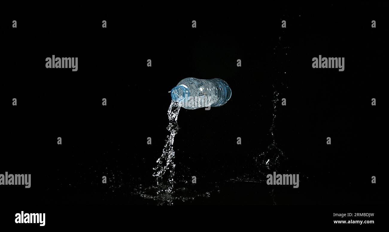 Plastic Bottle of Water falling and Splashing against Black Background ...