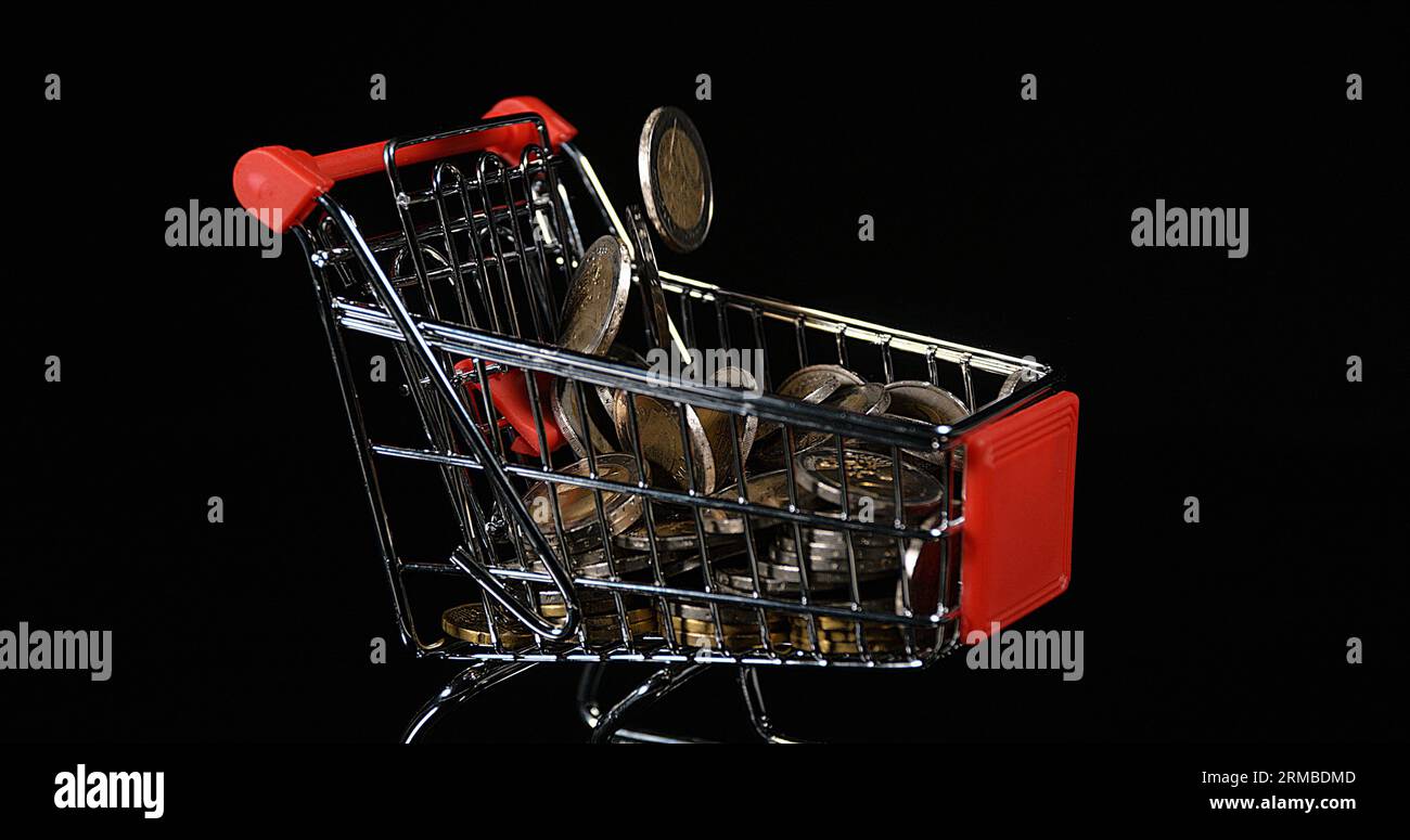 Euro Coins in Trolley rolling against Black Background Stock Photo - Alamy