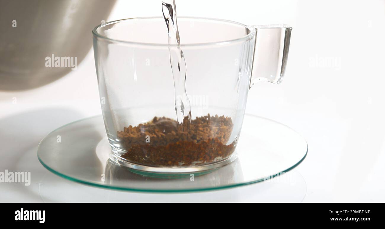 Instant Coffee Being Poured in a Cup against White Background Stock ...