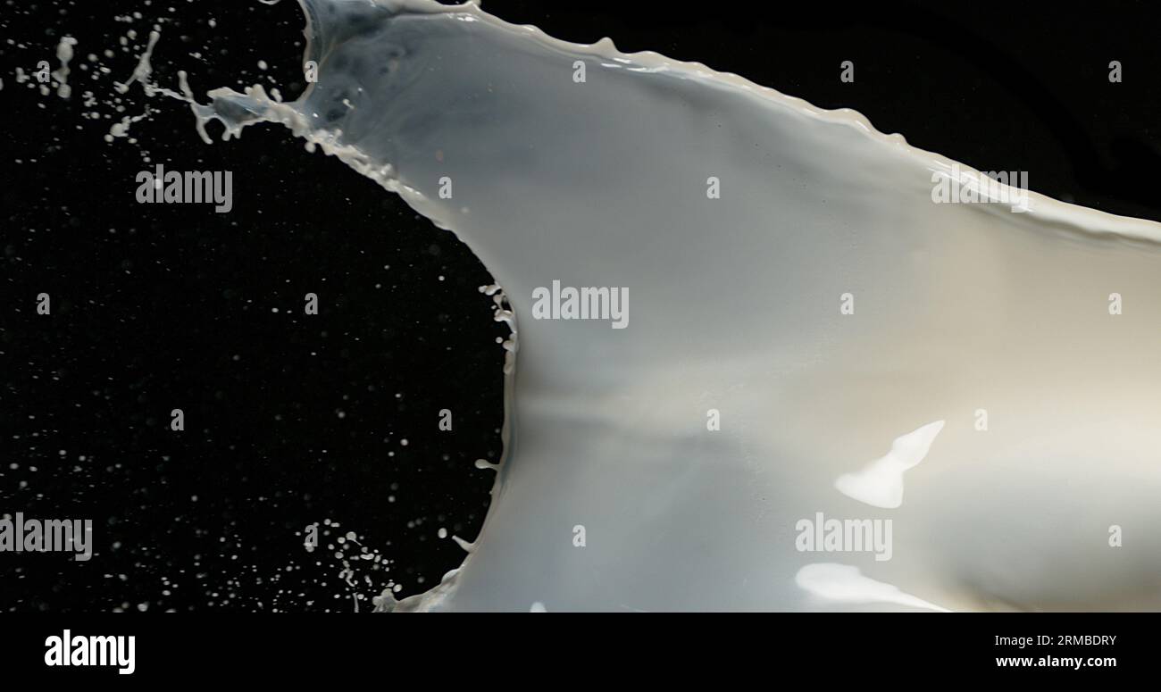 Exploding Milk against Black Background Stock Photo - Alamy