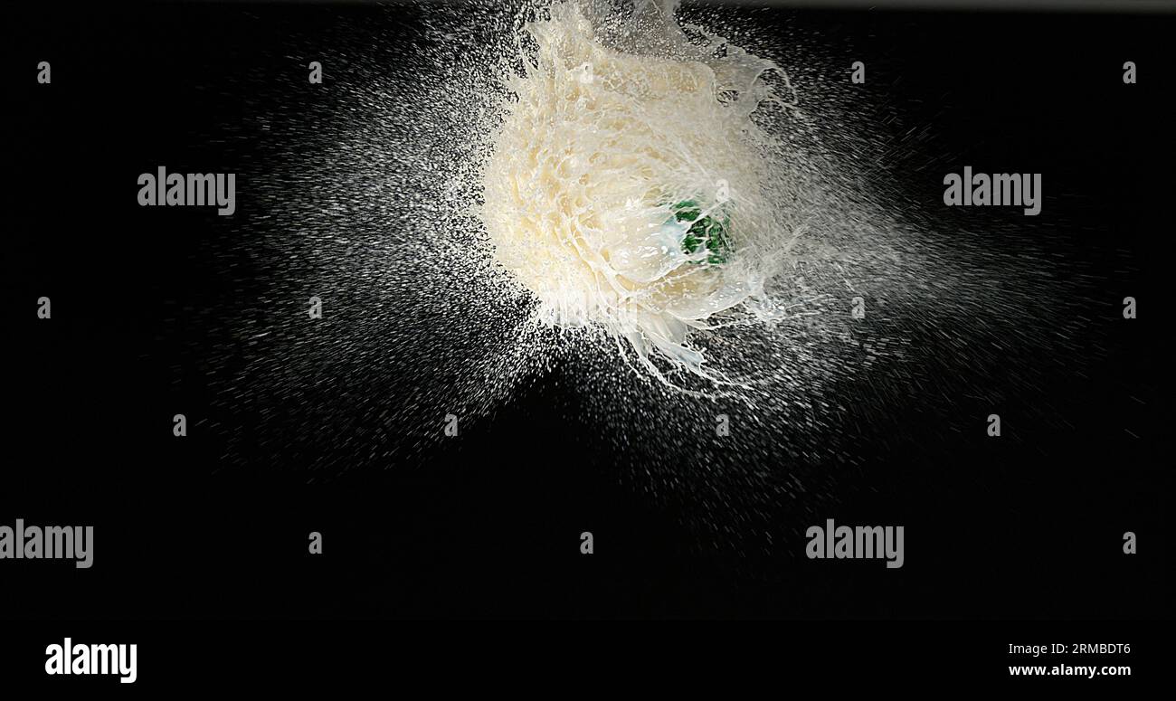 Shot Breaking Milk Filled Balloon Stock Photo - Alamy
