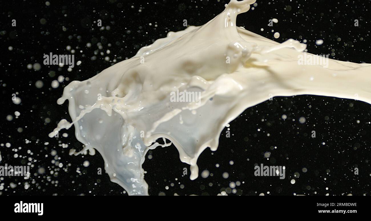 Exploding Milk against Black Background Stock Photo - Alamy