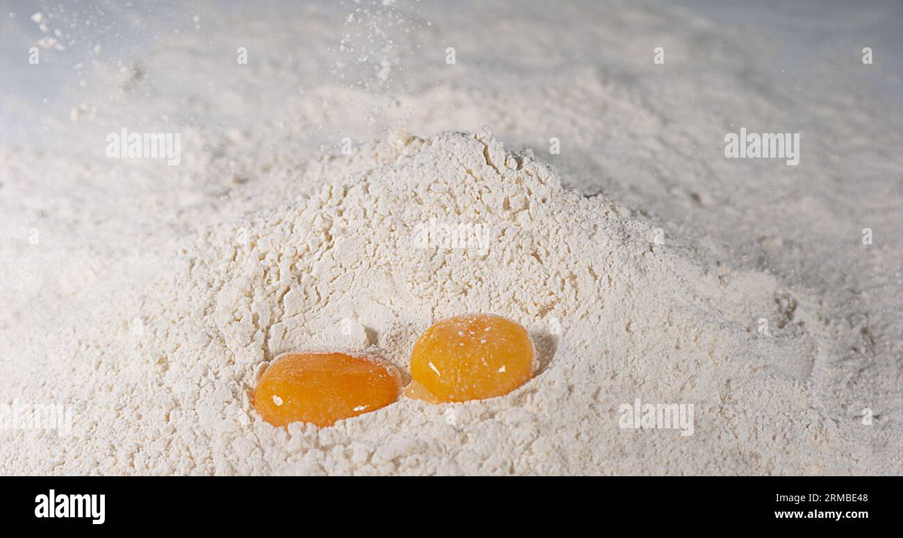 Egg Falling into Flour against White Background Stock Photo - Alamy