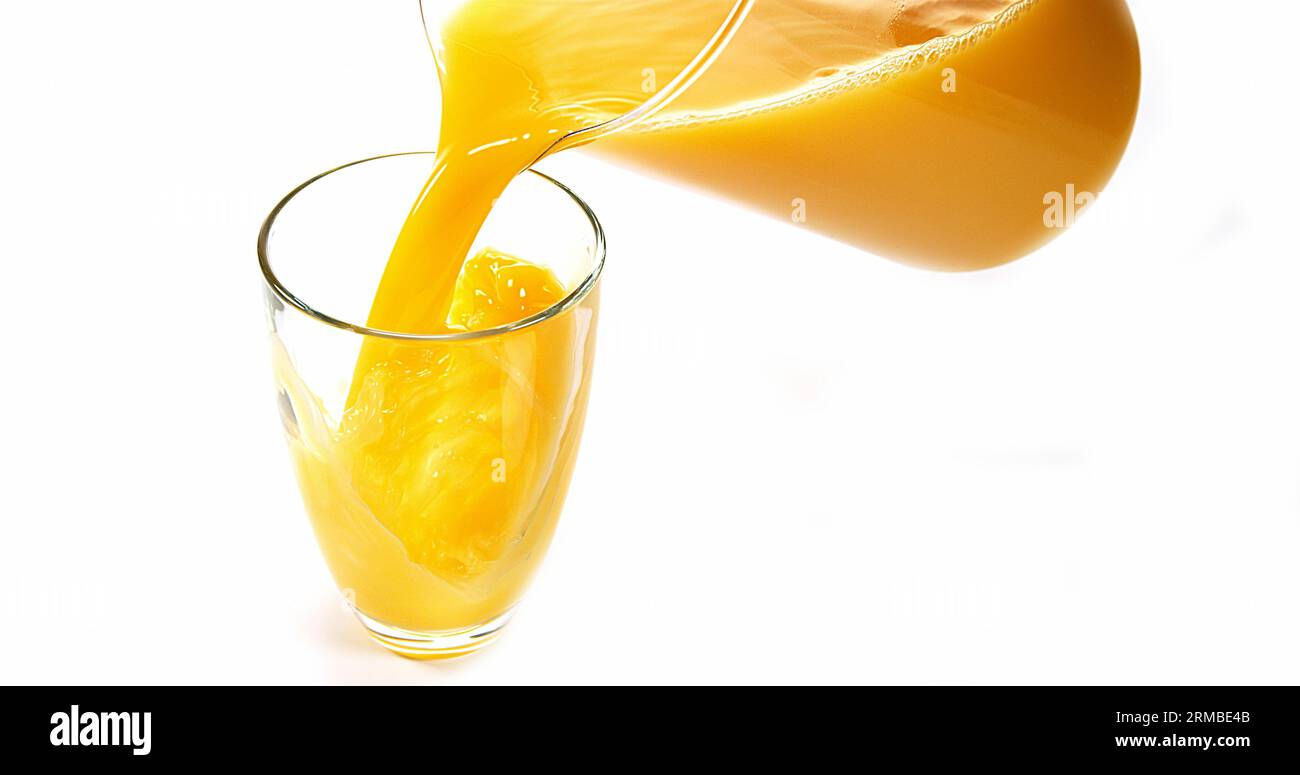 Orange Juice being poured into Glass against White Background Stock ...