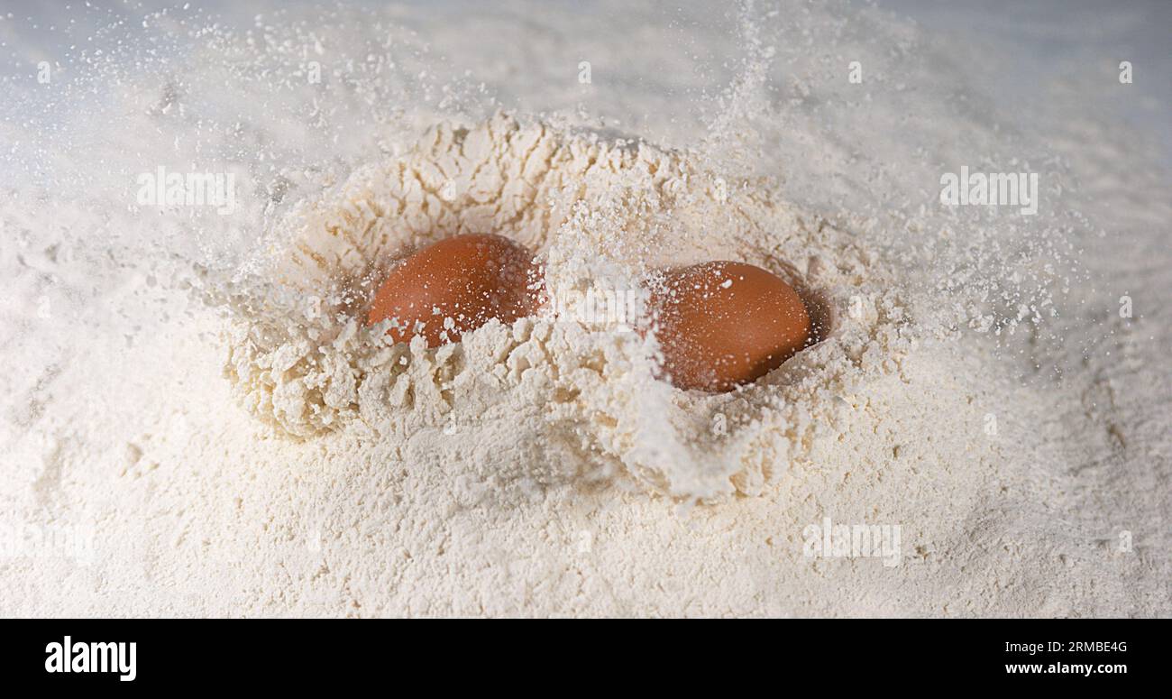 Egg Falling into Flour against White Background Stock Photo - Alamy