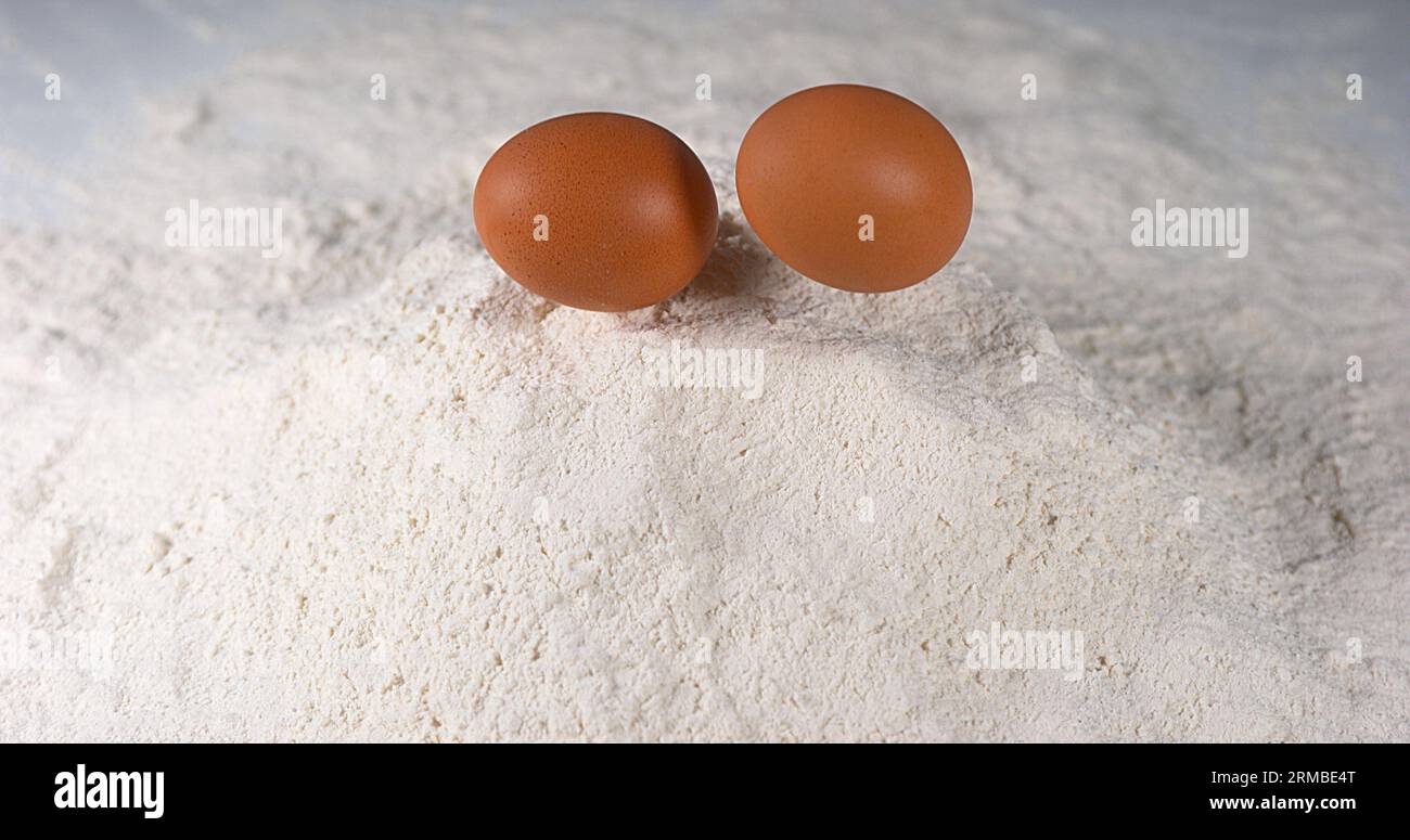Egg Falling into Flour against White Background Stock Photo - Alamy