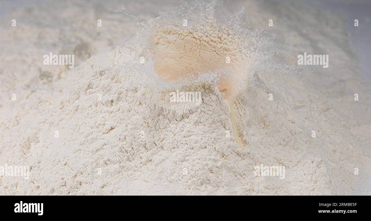 Egg Falling into Flour against White Background Stock Photo - Alamy