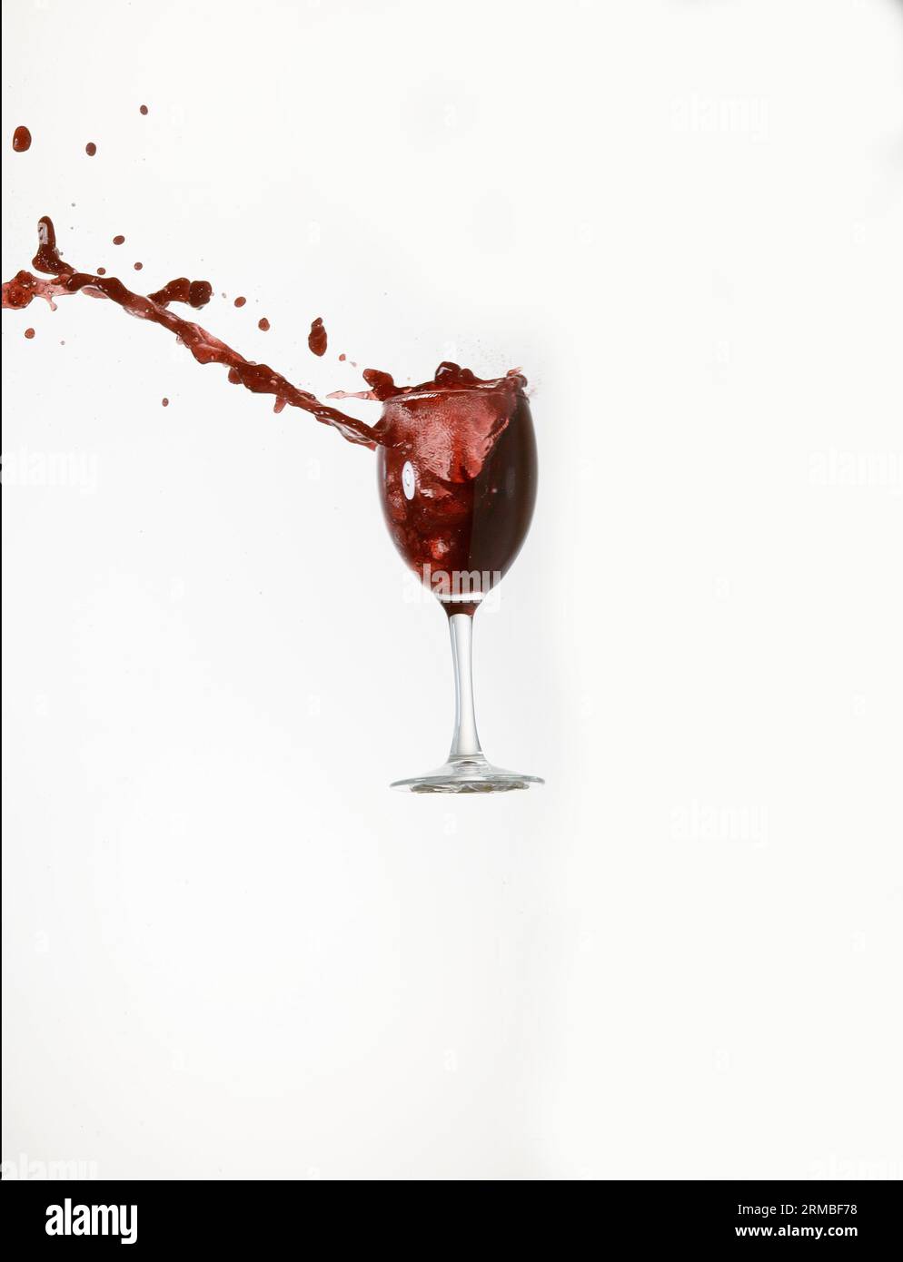 Glass of Red Wine Breaking and Splashing against White Background Stock ...