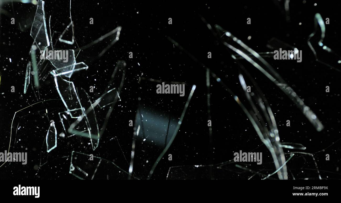 Tennis Ball breaking Pane of Glass against Black Background Stock Photo ...