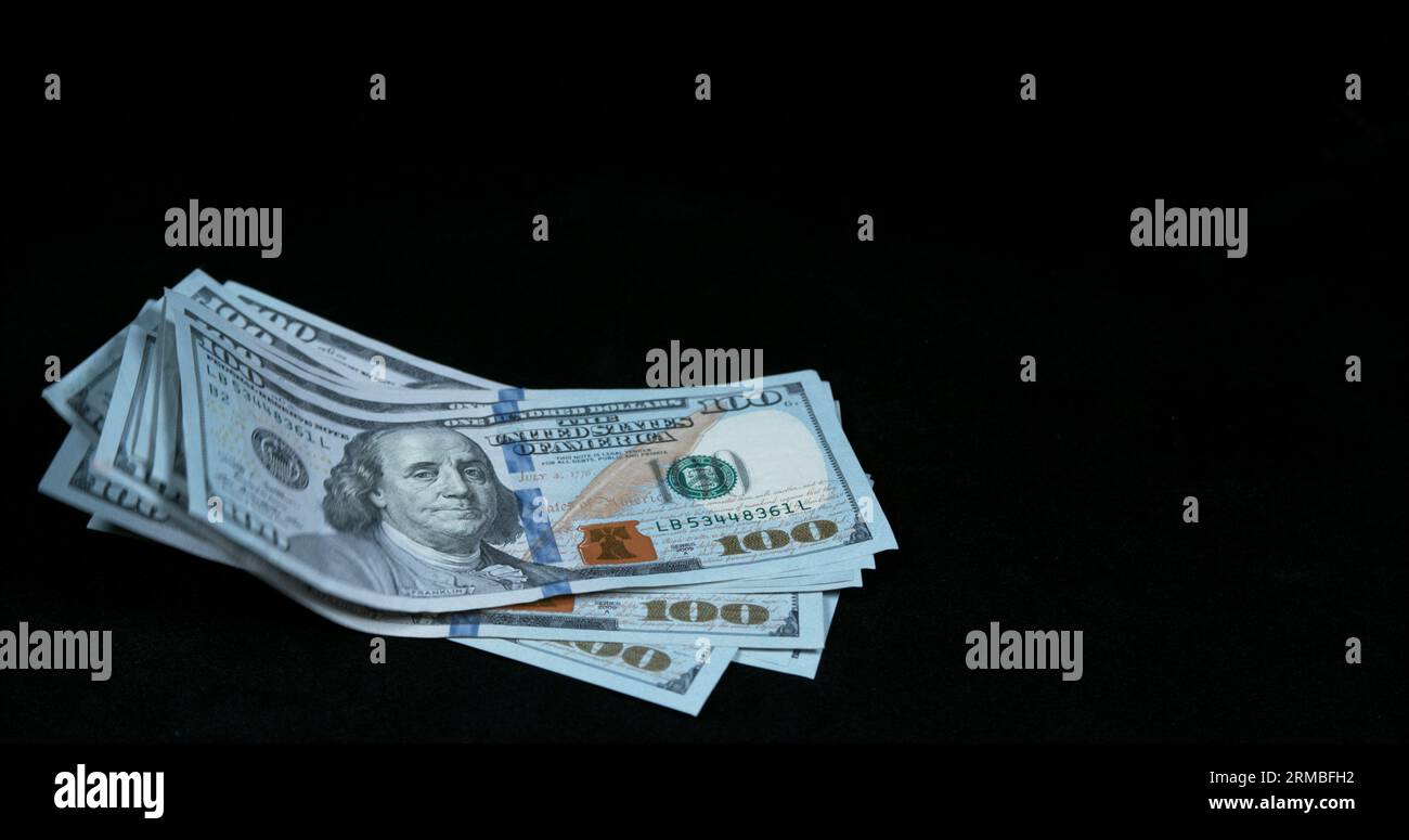 100 US Dollars Banknotes against Black background Stock Photo - Alamy