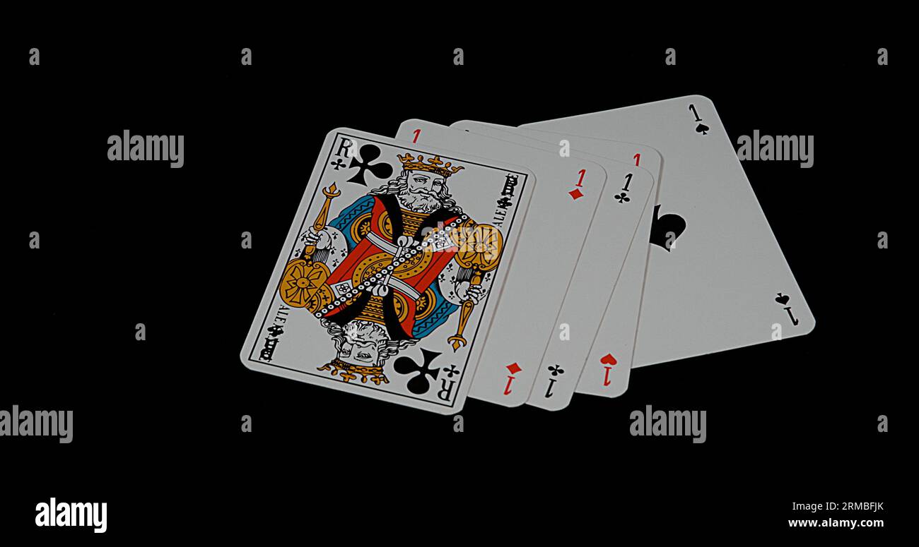 Playing Cards, Four Aces and One King falling againt Black Background ...