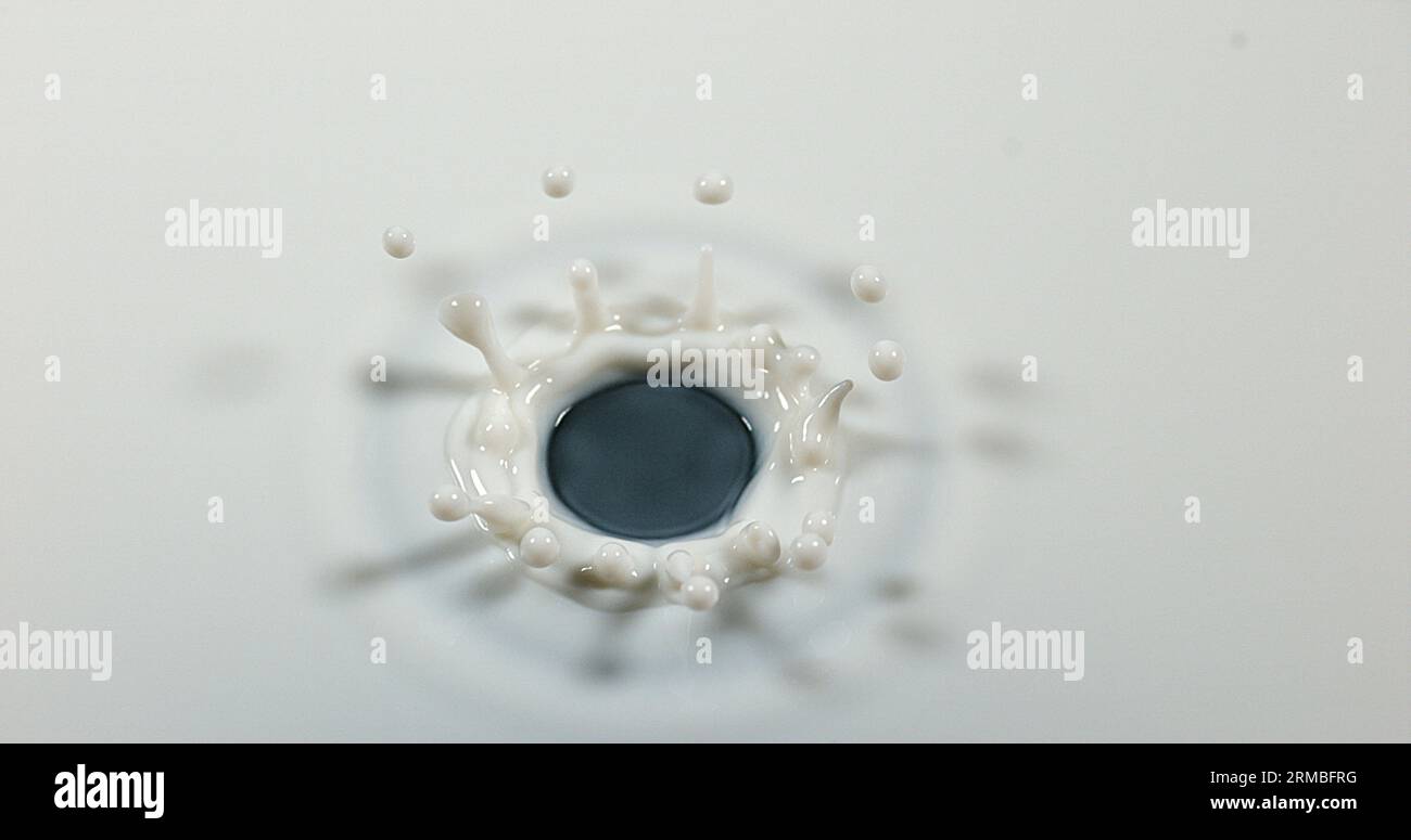 Drop of Milk Falling Stock Photo - Alamy