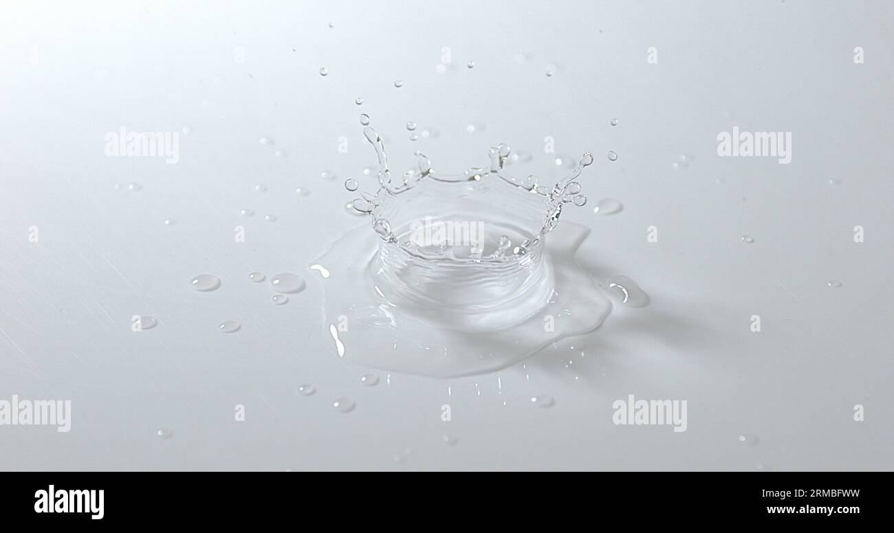 Drop of Water falling into Water Stock Photo - Alamy