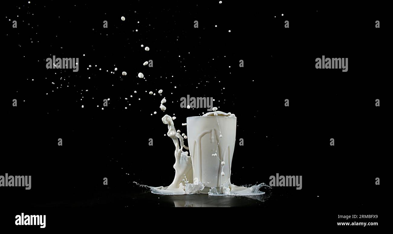 Glass of Milk Exploding against White Background Stock Photo - Alamy