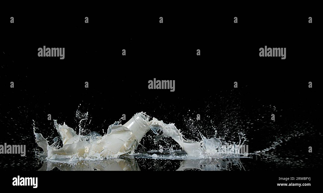 Bottle of Milk Falling and Exploging against Black Background Stock ...
