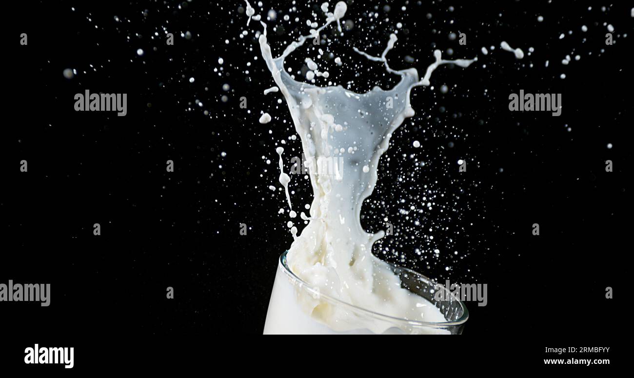 Exploding Milk against Black Background Stock Photo - Alamy