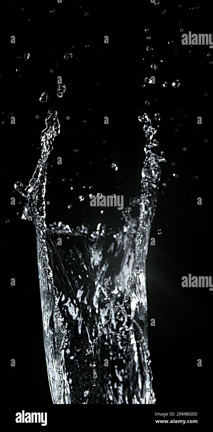 Water spurting out against Black Background Stock Photo - Alamy