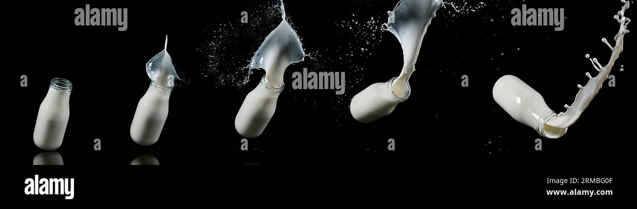 Bottle of Milk Falling and Exploging against Black Background Stock ...