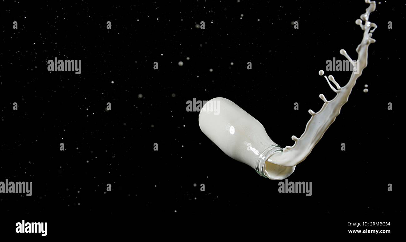 Bottle of Milk Falling and Exploging against Black Background Stock ...