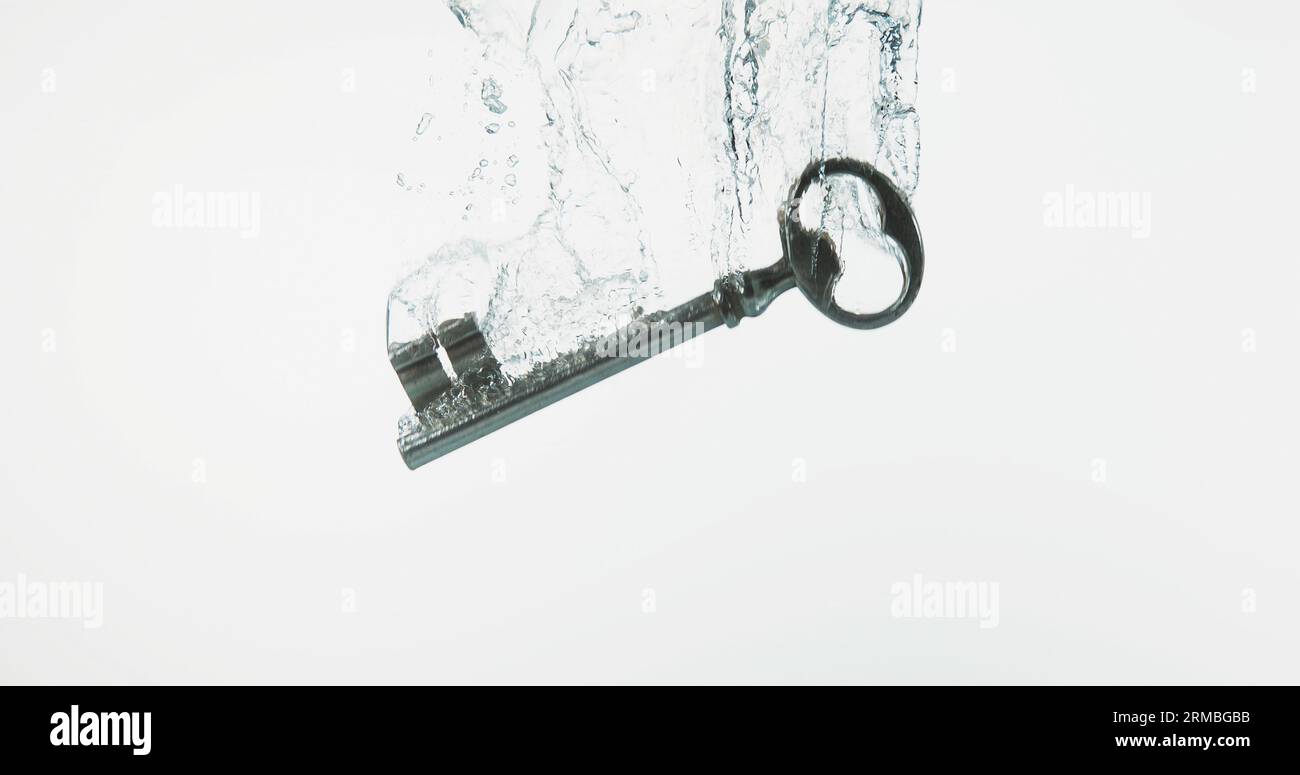 Key falling into Water agaisnt White Background Stock Photo - Alamy