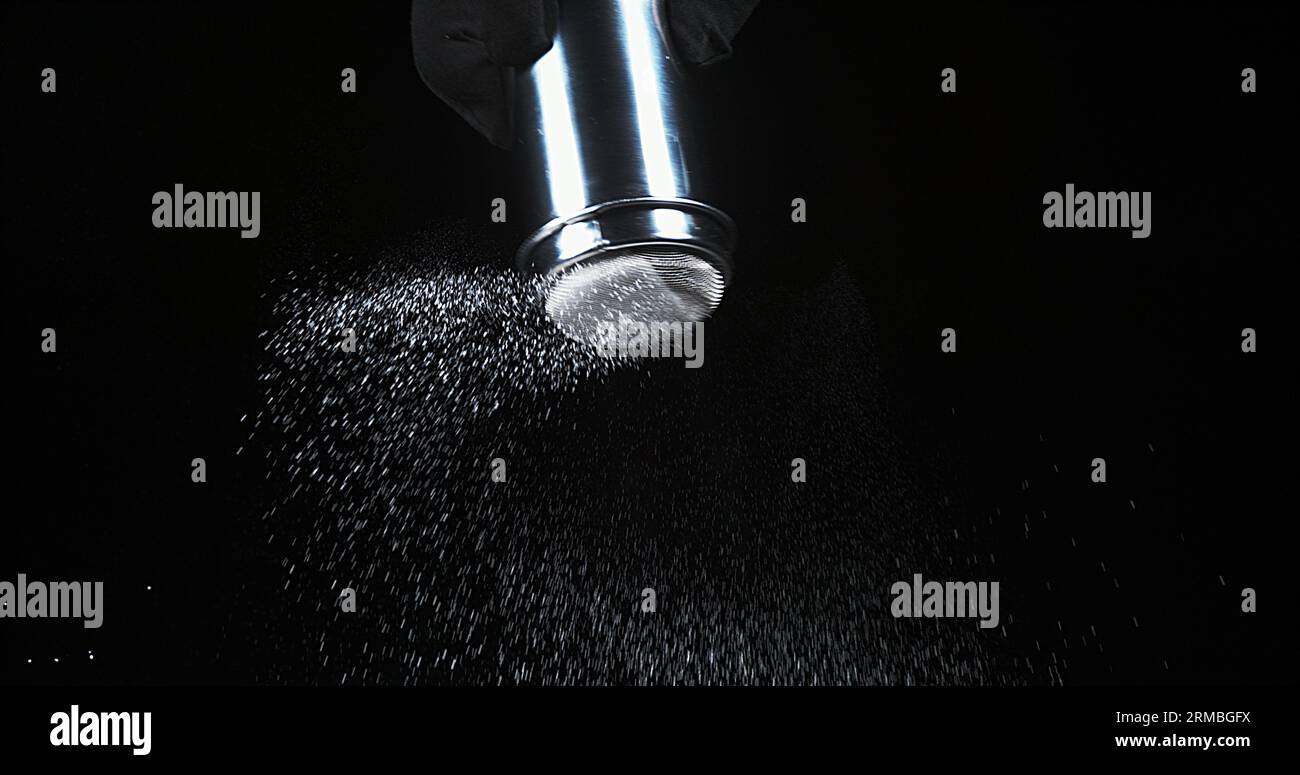 White Sugar falling against Black Background Stock Photo - Alamy