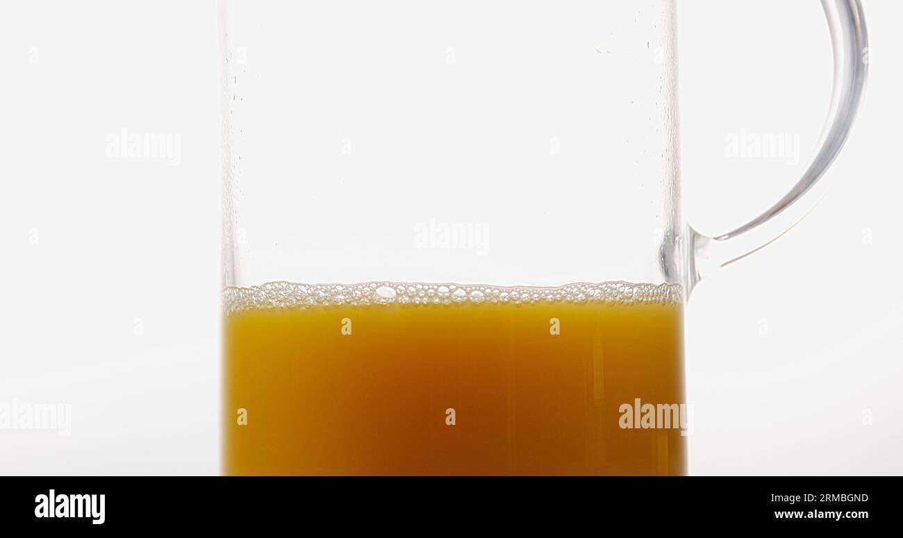 Orange Juice being poured into Glass against White Background Stock ...
