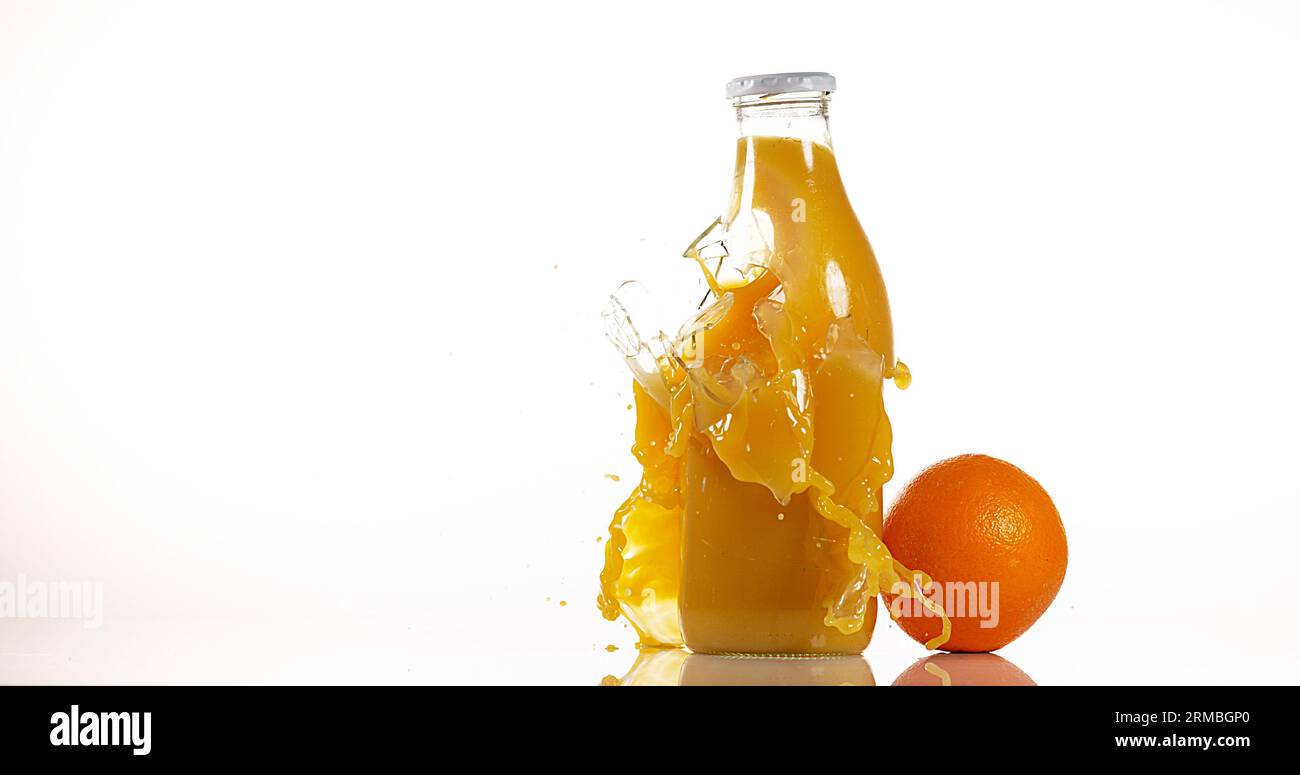Bottle of Orange Exploding against White Background Stock Photo - Alamy