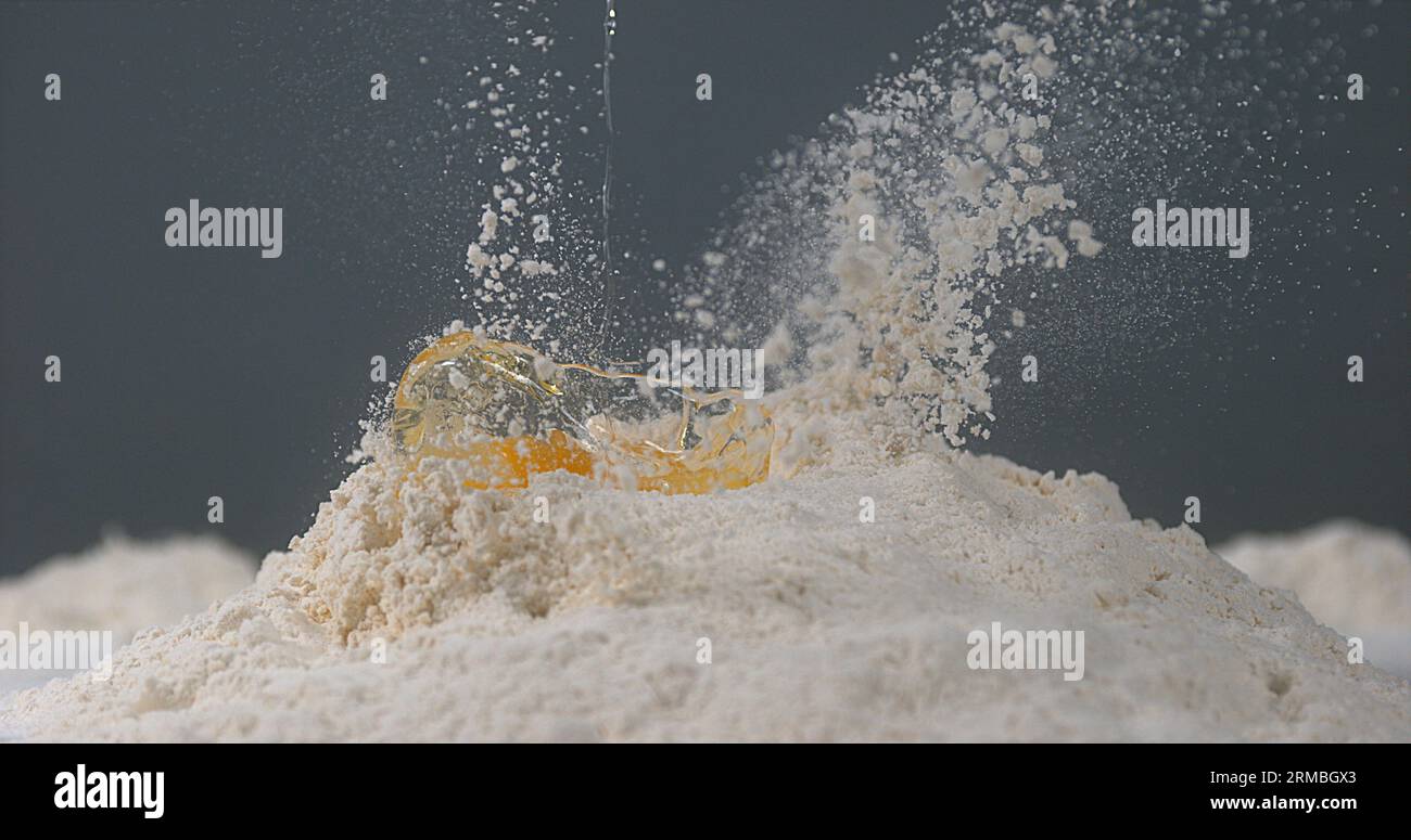 Egg Falling on Flour Stock Photo - Alamy
