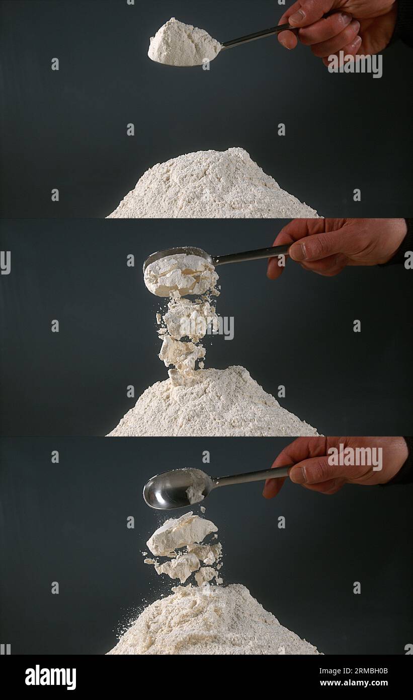 Flour falling against Black Background Stock Photo - Alamy