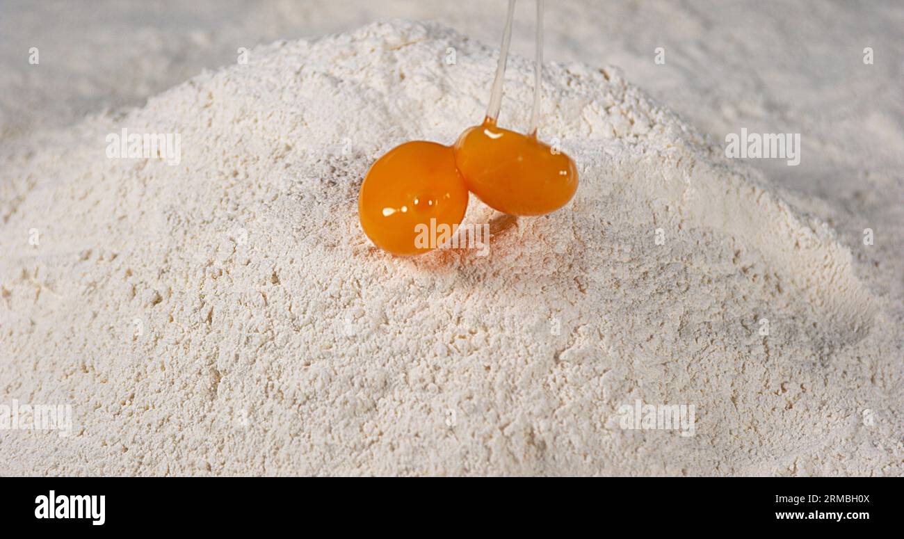 Egg Falling on Flour Stock Photo - Alamy