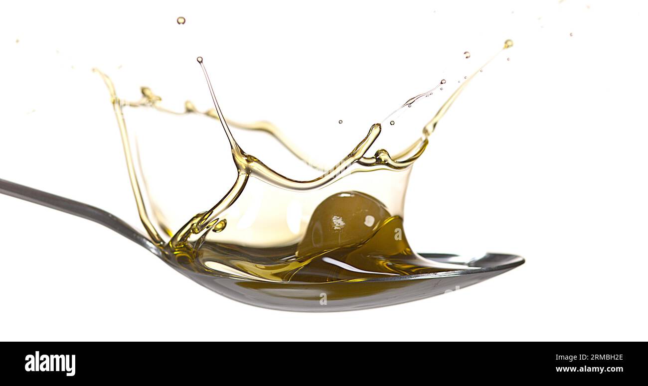 Olive Falling into Olive Oil against White Background Stock Photo - Alamy