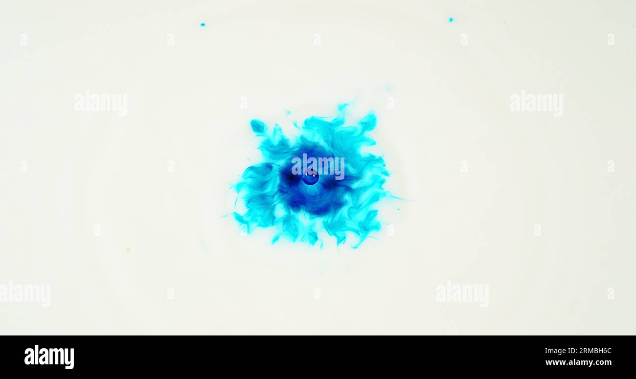 Blue Liquid falling into Water against White Background Stock Photo - Alamy