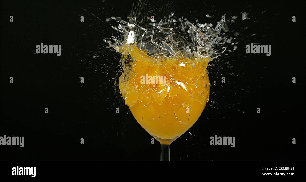 Glass of Orange Exploding against Black Background Stock Photo - Alamy