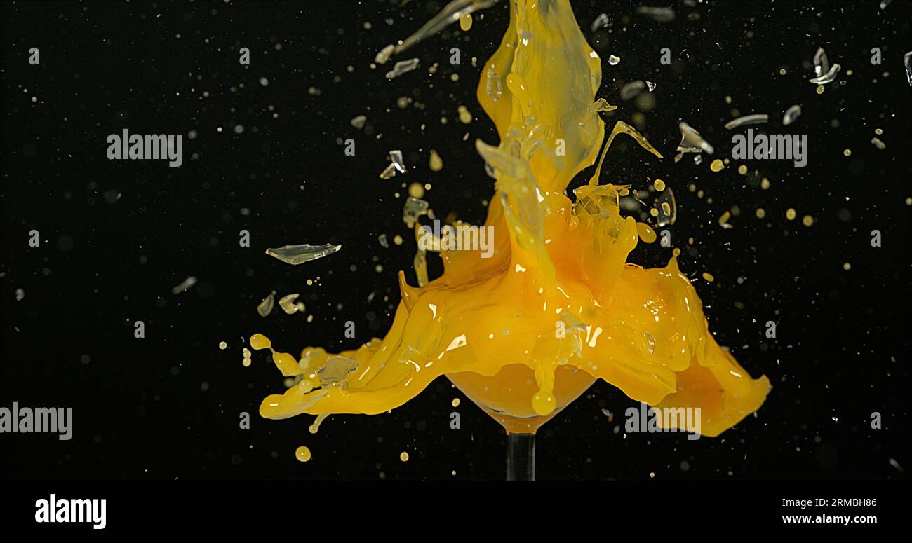 Glass of Orange Exploding against Black Background Stock Photo - Alamy