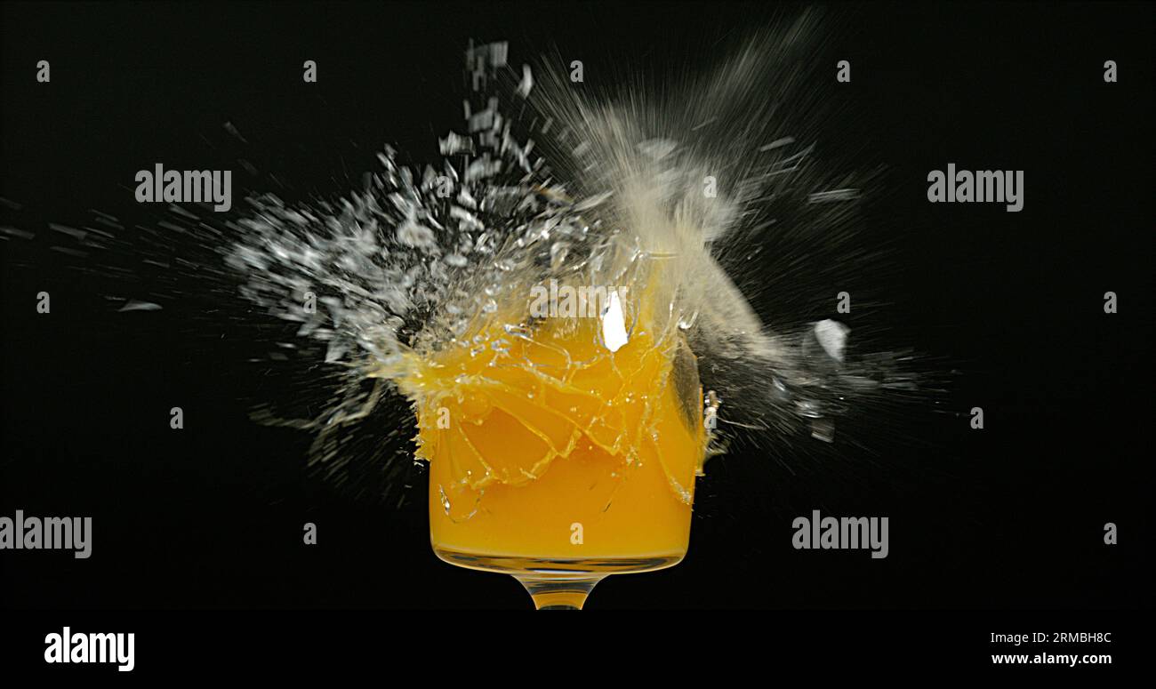 Glass of Orange Exploding against Black Background Stock Photo - Alamy