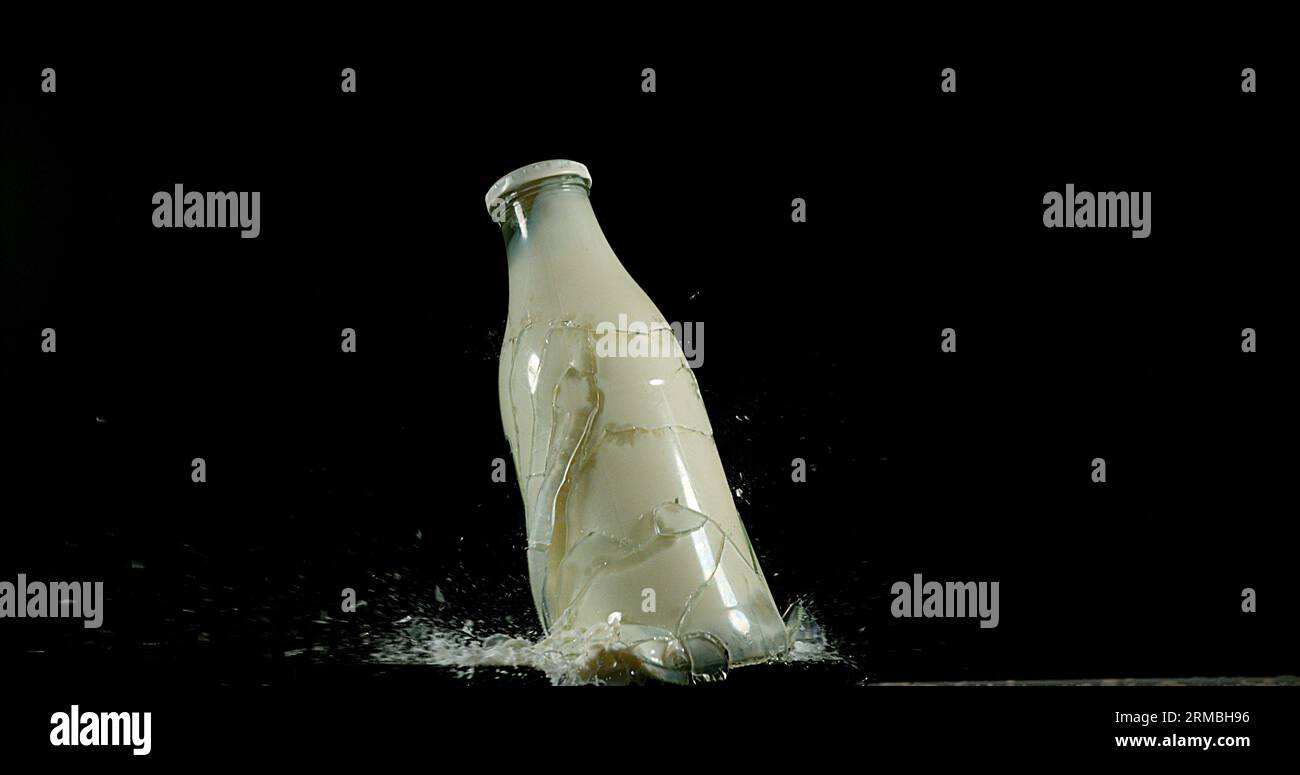 Bottle of Milk Exploding against Black Background Stock Photo - Alamy