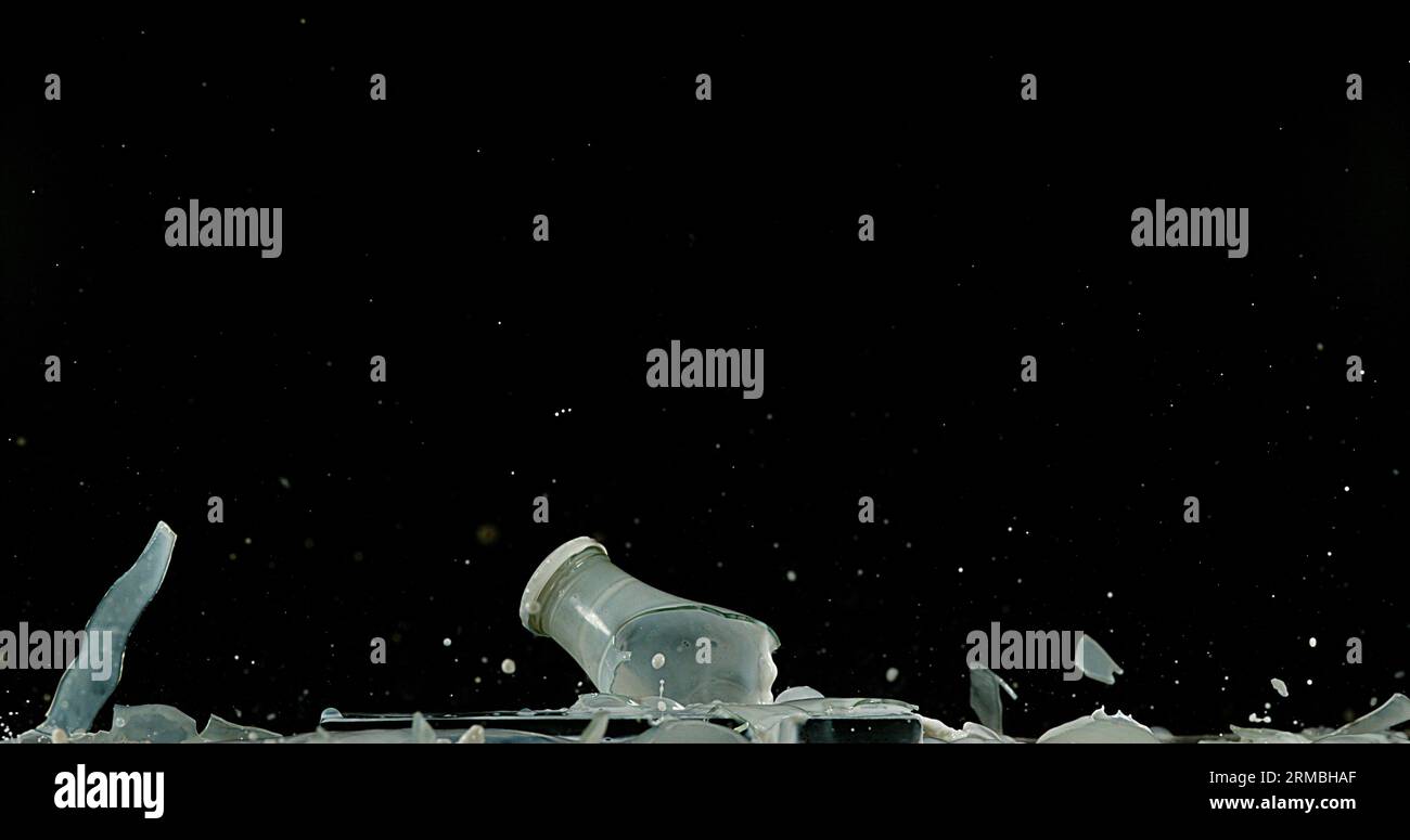 Bottle of Milk Exploding against Black Background Stock Photo - Alamy