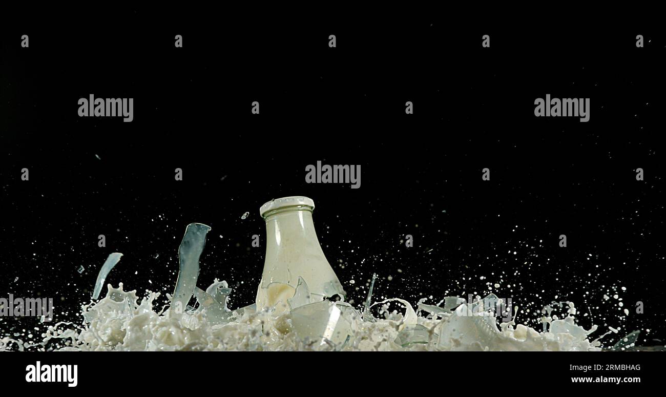 Bottle of Milk Exploding against Black Background Stock Photo - Alamy