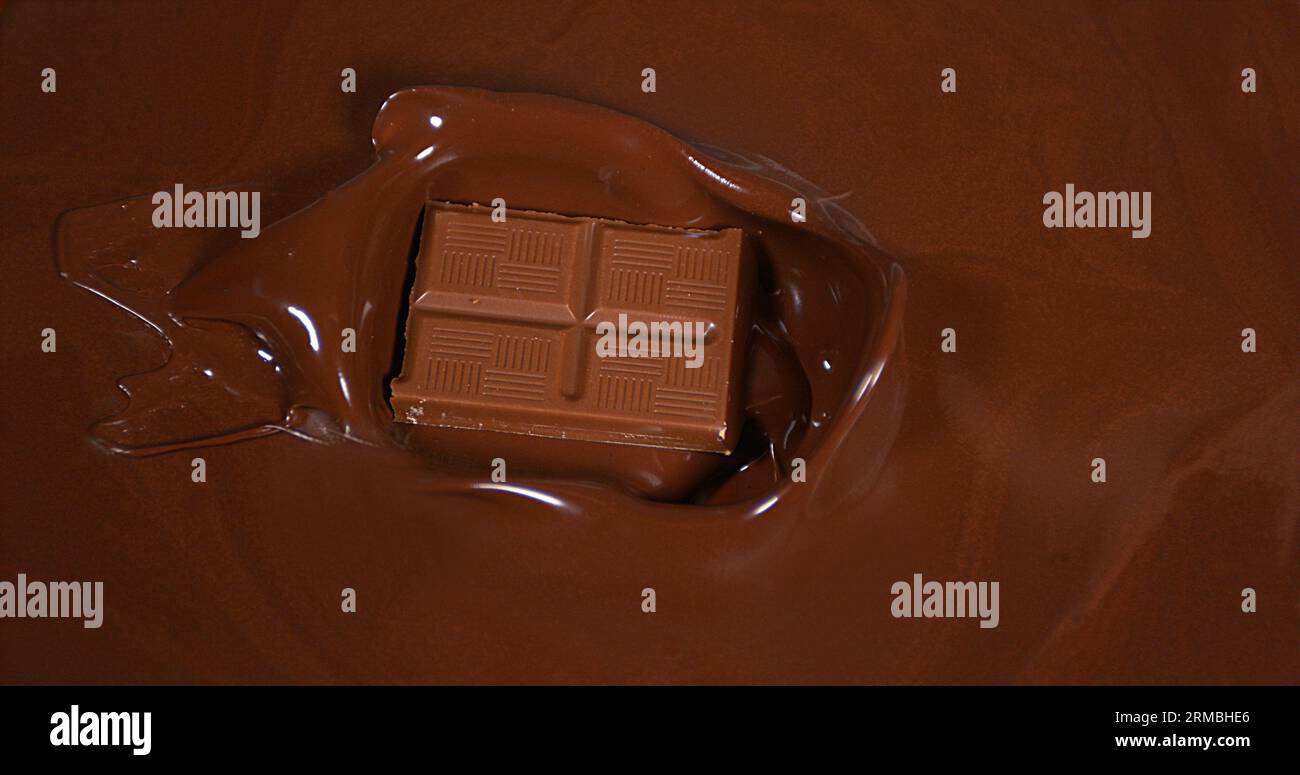 Chocolate tablet falling into Milk Chocolate Stock Photo - Alamy
