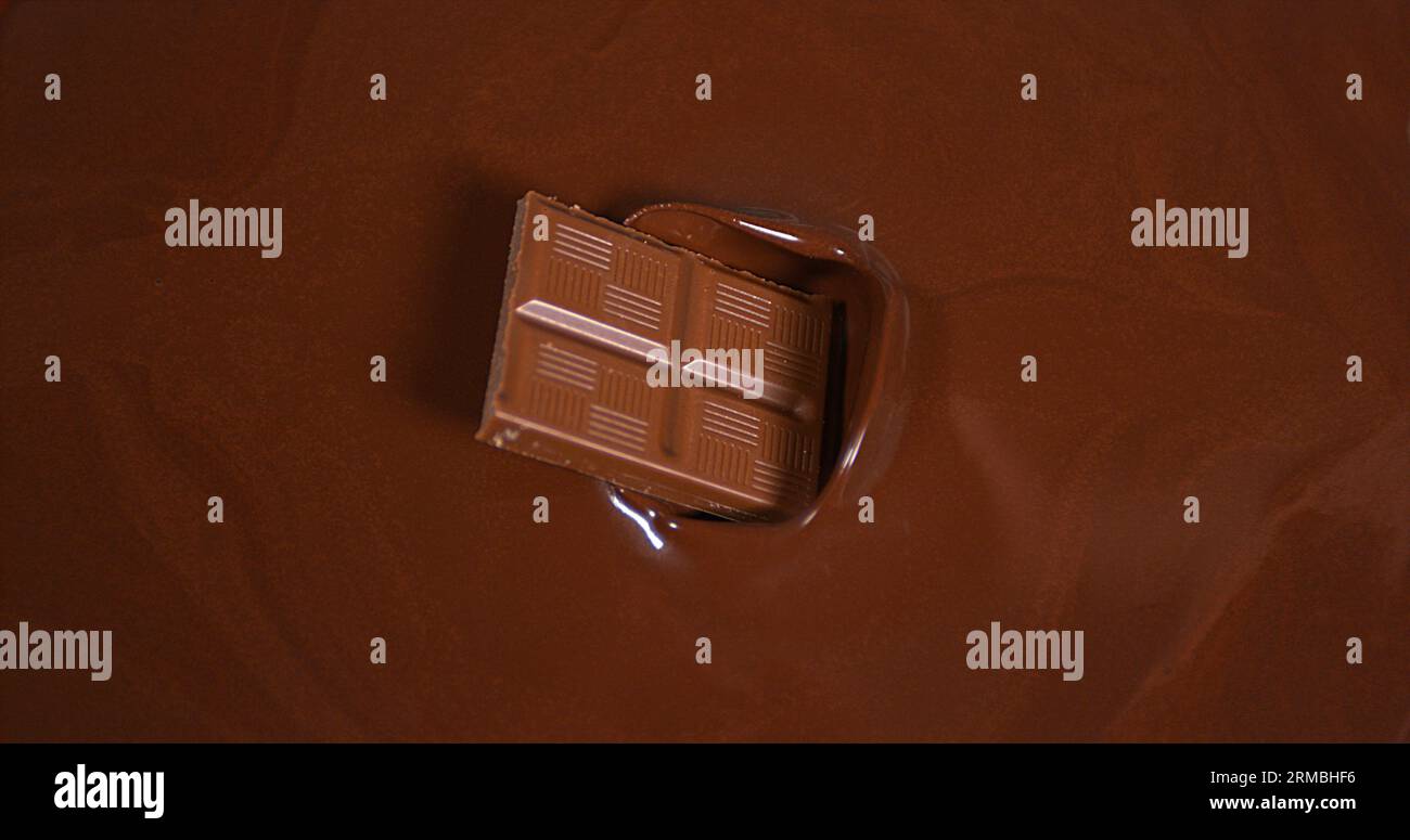 Chocolate tablet falling into Milk Chocolate Stock Photo - Alamy