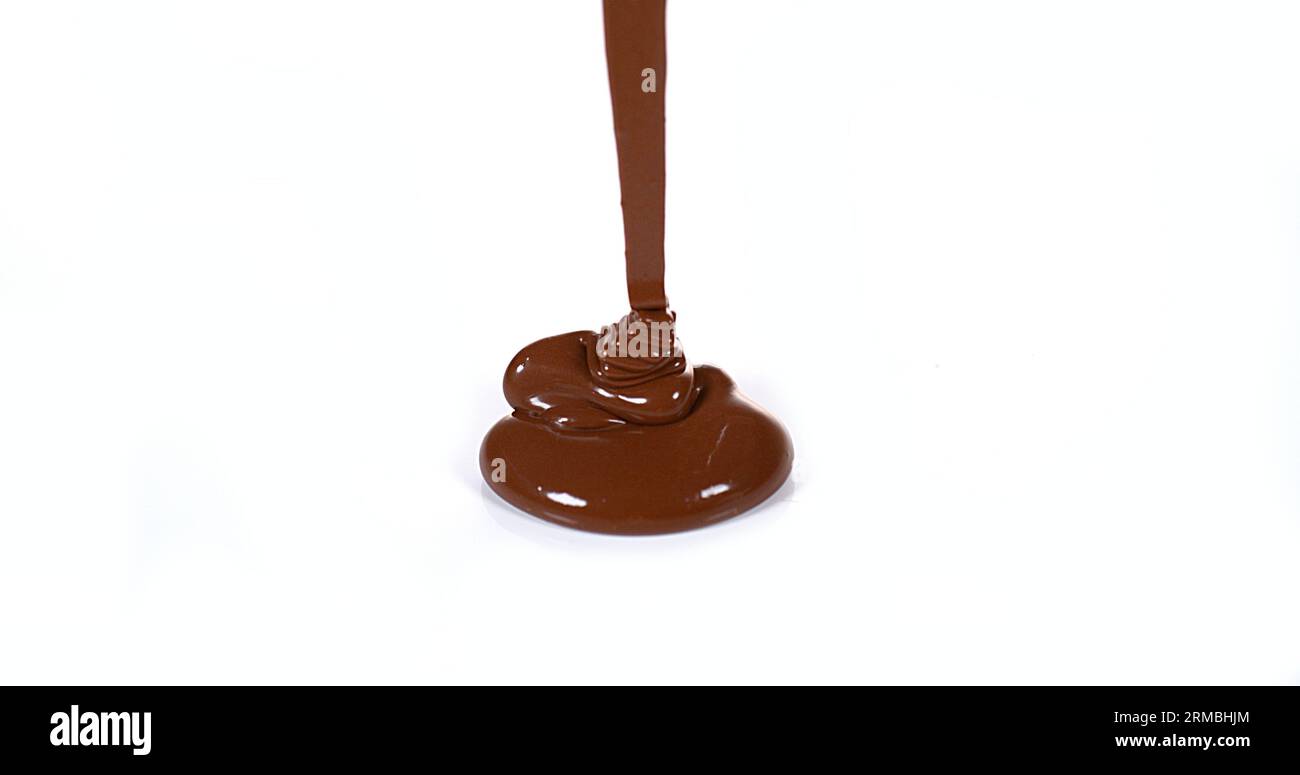 Chocolate Flowing on White Background Stock Photo - Alamy