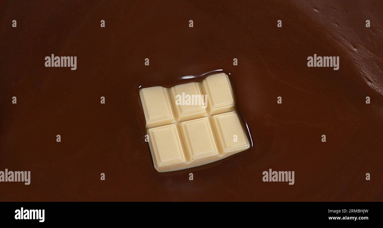White Chocolate Tablet falling into Milk Chocolate Stock Photo - Alamy
