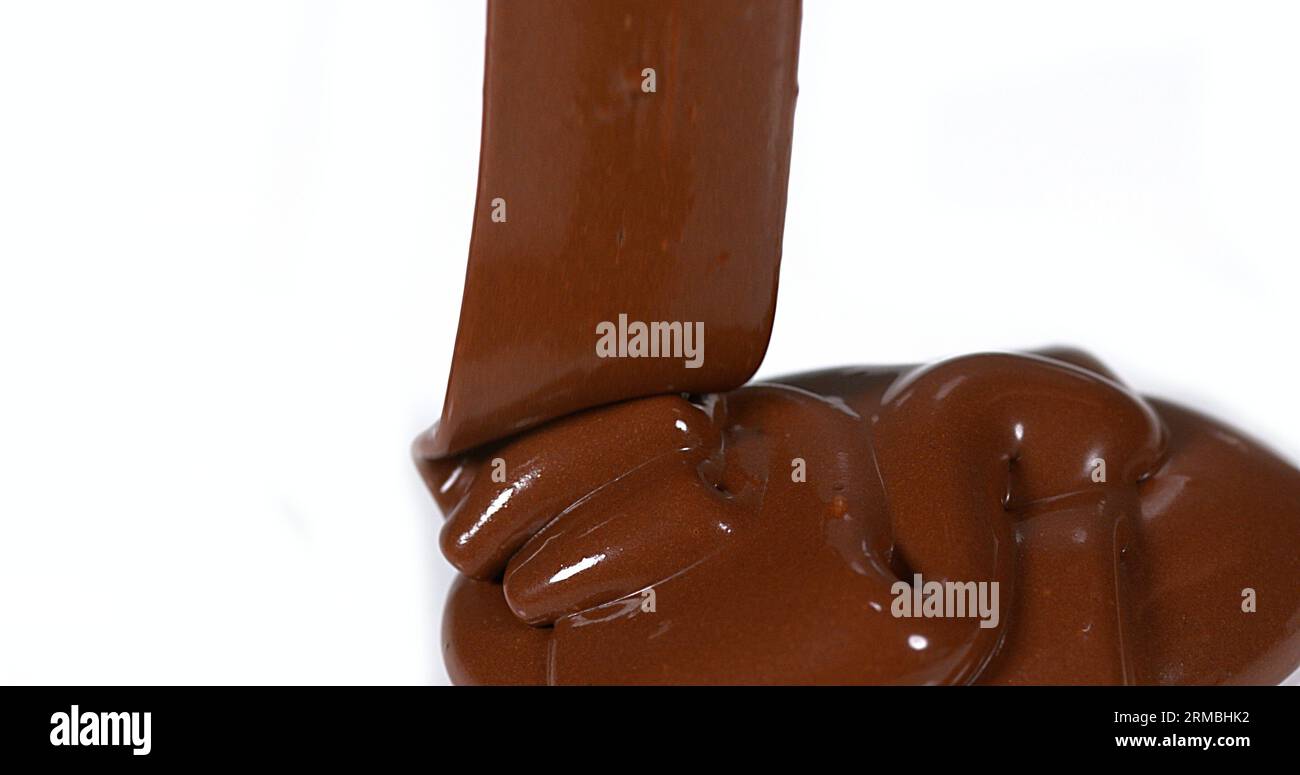 Chocolate Flowing on White Background Stock Photo - Alamy