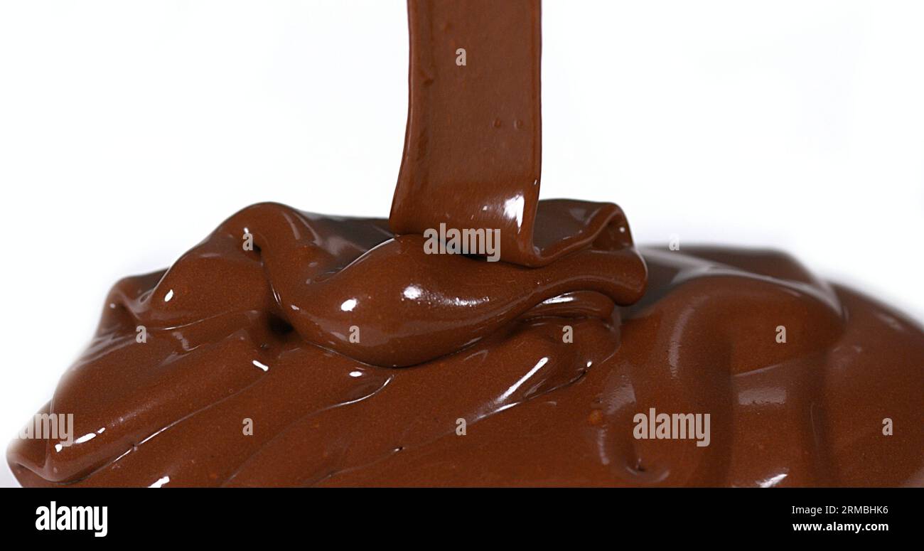 Chocolate Flowing on White Background Stock Photo - Alamy