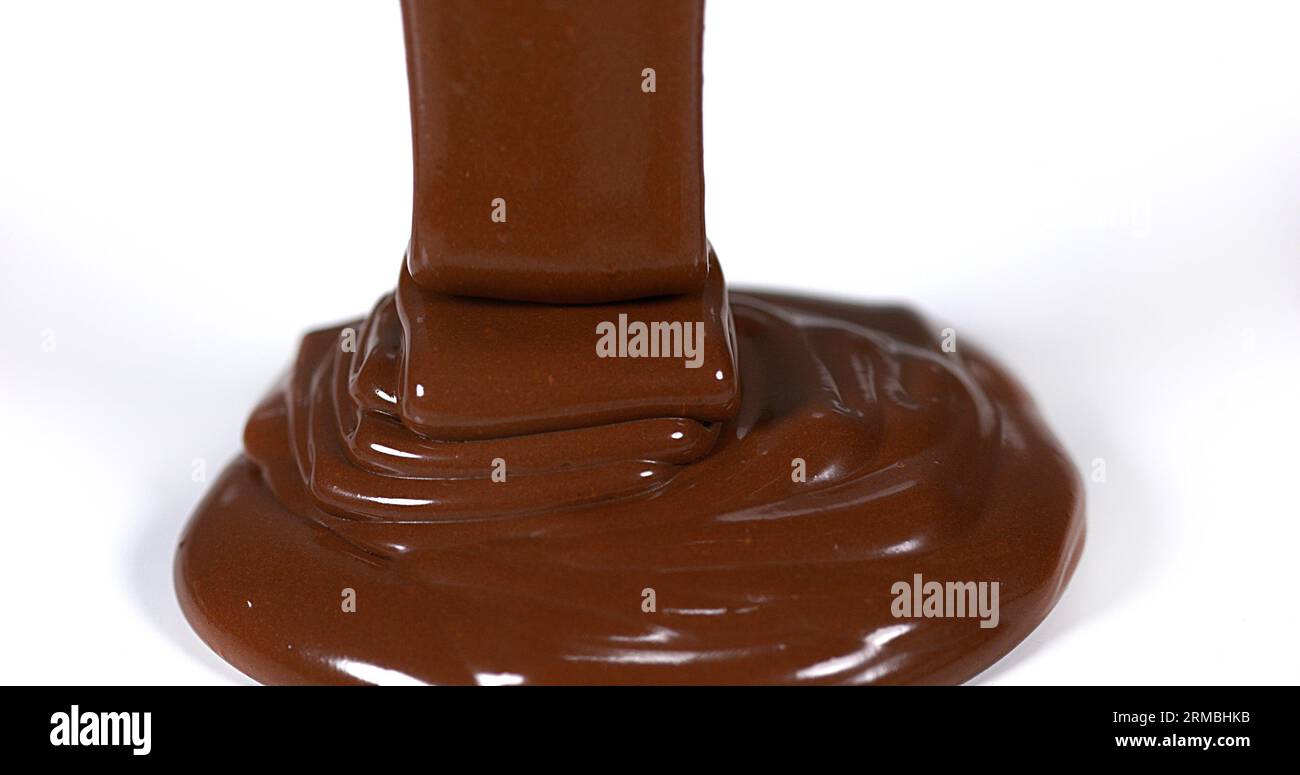 Chocolate Flowing on White Background Stock Photo - Alamy