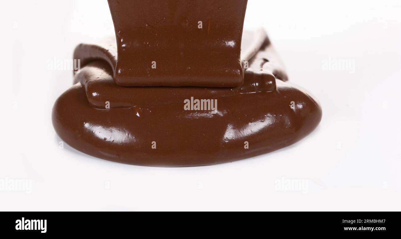 Chocolate Flowing on White Background Stock Photo - Alamy