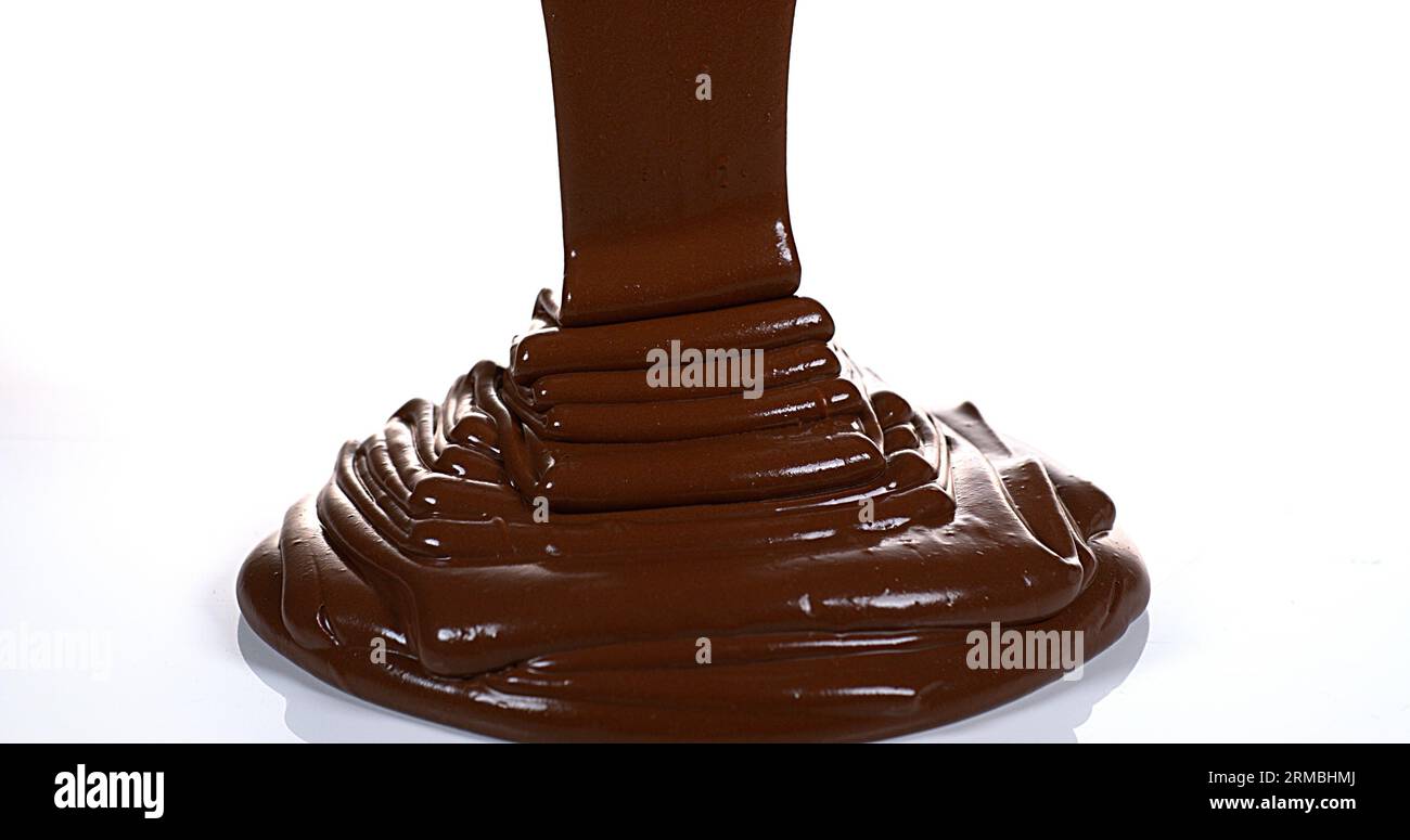 Chocolate Flowing on White Background Stock Photo - Alamy
